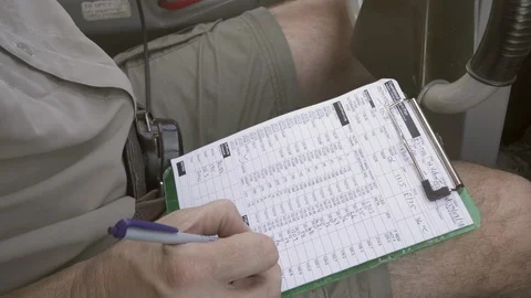 Close-up of pilot writing on checklist w... | Stock Video | Pond5