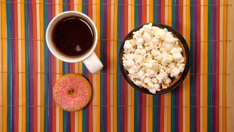 Close up of popcorn in a bowl with tea a... | Stock Video | Pond5