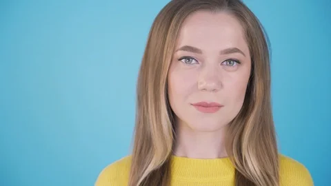 Close-up portrait. Calm girl on a blue b... | Stock Video | Pond5