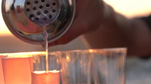 Close-up pouring shots outdoors against ... | Stock Video | Pond5