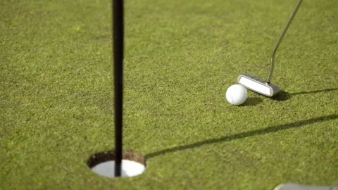 Close-up of putting golf ball into hole | Stock Video | Pond5