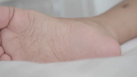 Close-Up of Relaxed Child Foot Resting o... | Stock Video | Pond5