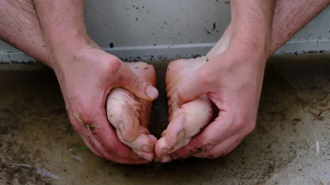 Close up of rubbing toes of bare feet in... | Stock Video | Pond5