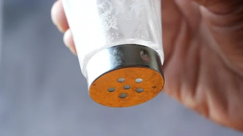 close up of salt pouring on table | Stock Video | Pond5