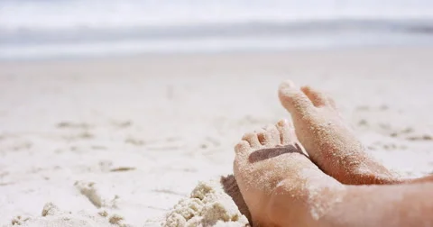 Close up of sandy feet wiggling toes two... | Stock Video | Pond5