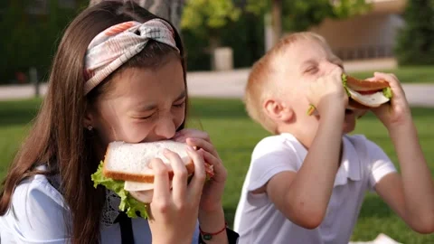 Close-up of school children biting fresh... | Stock Video | Pond5