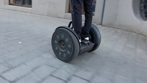 Close Up of a Segway Wheels Riding throu... | Stock Video | Pond5