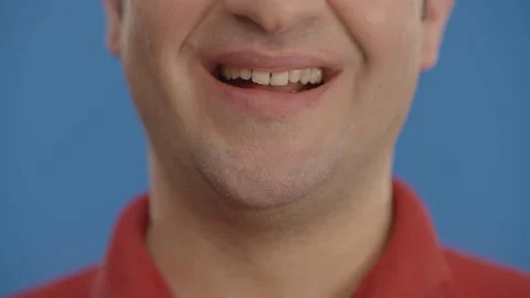 Close-up serious young man mouth smile i... | Stock Video | Pond5