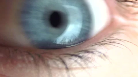 Close up shot of a blue eye looking side... | Stock Video | Pond5