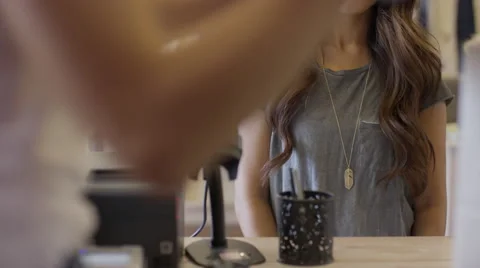Close up shot of cashier bagging clothin... | Stock Video | Pond5