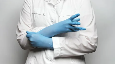 Close up shot of a doctor pulling up blu... | Stock Video | Pond5