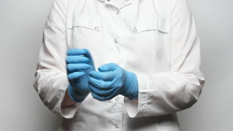Close up shot of a doctor pulling up blu... | Stock Video | Pond5