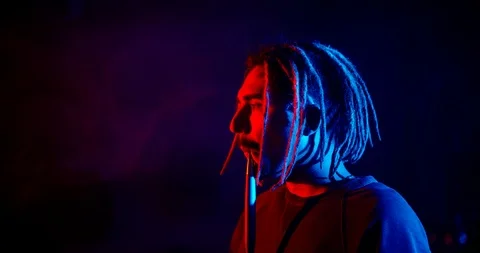 Close up shot of guy with dreadlocks smo... | Stock Video | Pond5