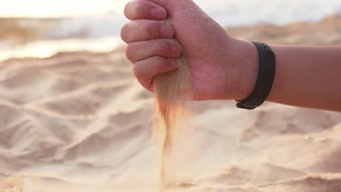 Close up shot of man holding sand and po... | Stock Video | Pond5