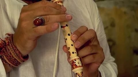 Close up shot of a monk playing flute in... | Stock Video | Pond5