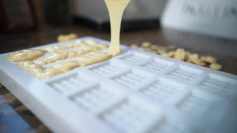 Close-up shot of pouring melted white ch... | Stock Video | Pond5