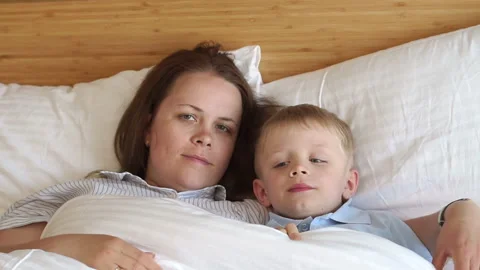Close-up of sleepy mom and son lying on ... | Stock Video | Pond5