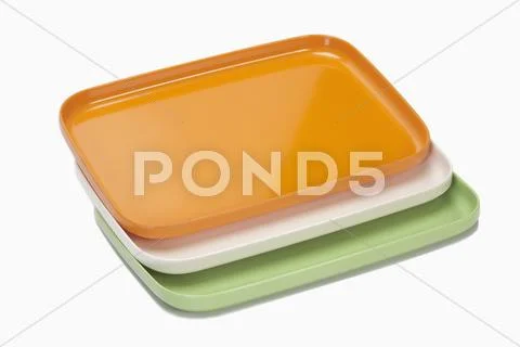 Close-up of a stack of colorful trays representing Indian flag colors ...