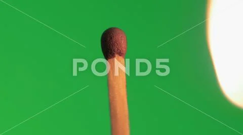 Close up of a standard lit match with a green screen background. Looks ...