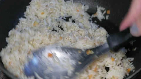 Close up Stirring fried rice in frying p... | Stock Video | Pond5