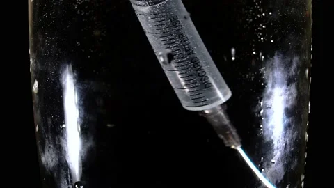 Close-up of a syringe floating in a glas... | Stock Video | Pond5