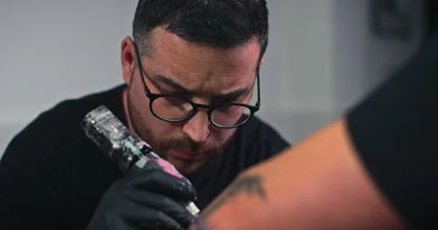 Close up tattoo artist shows the process... | Stock Video | Pond5