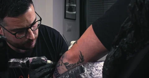 Close up tattoo artist shows the process... | Stock Video | Pond5