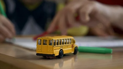 Close-up Toy School Bus at Desk. On Blur... | Stock Video | Pond5