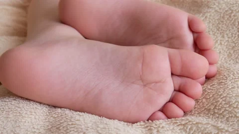 Close-up of two child's feet lying on a ... | Stock Video | Pond5