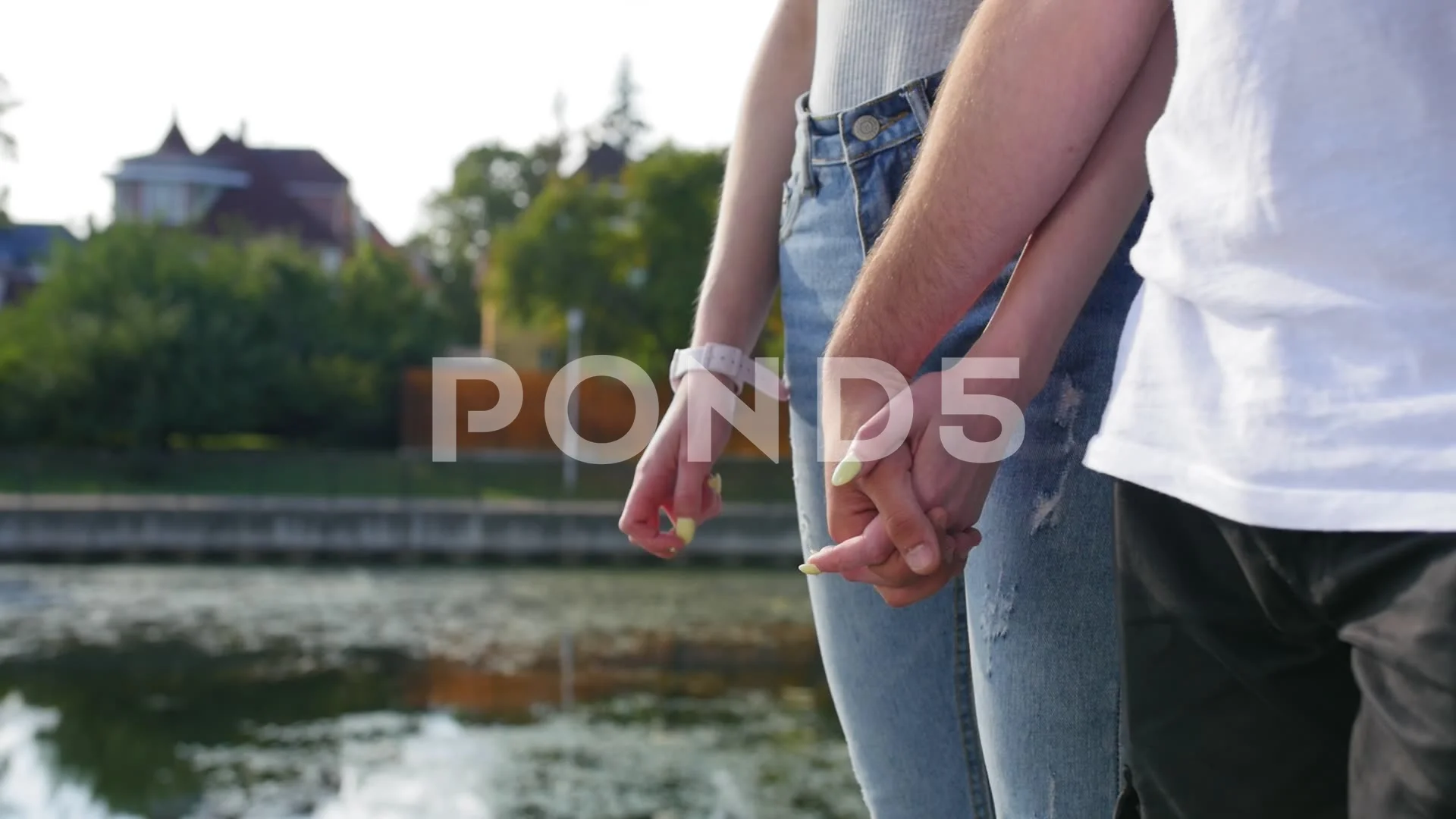 Two Teen Girls Hold Hands At Lake