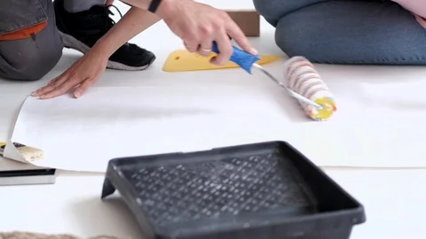 close up for two people putting glue on ... | Stock Video | Pond5