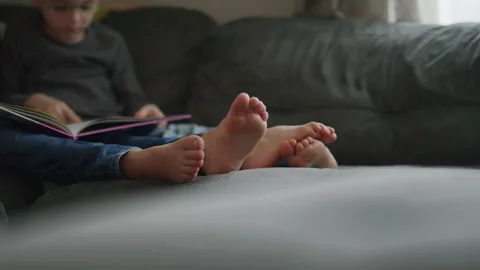 Close-up of Two Young Brothers Feet as T... | Stock Video | Pond5