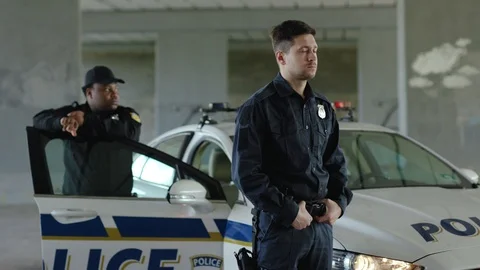 Close up two young men cops stand near p... | Stock Video | Pond5