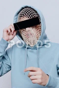 A close vertical studio photograph of a strange man with a grid and ...
