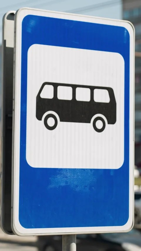 Close View of City Bus Stop Sign with Bu... | Stock Video | Pond5