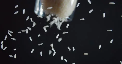 Close up view of falling rice on glass t... | Stock Video | Pond5