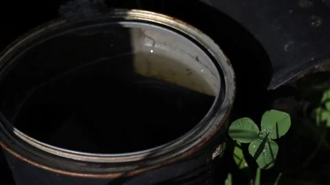 Close Up Water Dripping into Bucket | Stock Video | Pond5