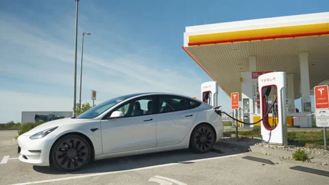 CLOSE UP: White Tesla electric car conne... | Stock Video | Pond5