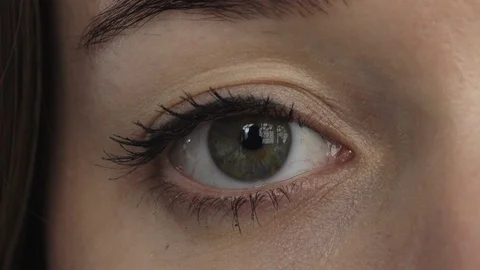 close up woman eye blinking looking at c... | Stock Video | Pond5