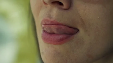 Close up of woman face licking lips HD | Stock Video | Pond5