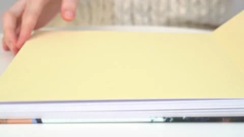 close up. woman flips through photo book... | Stock Video | Pond5