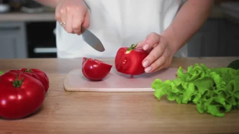 Close-up of a woman's hand cutting a tom... | Stock Video | Pond5