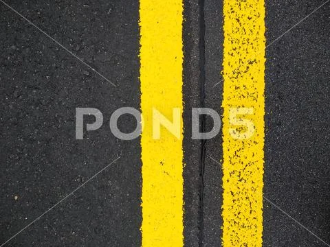 Close-up yellow dividing lines on the road with copy space. Yellow ...