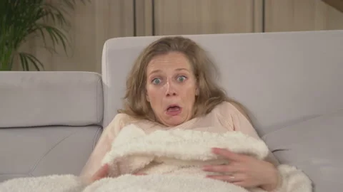 CLOSE UP: Young lady getting scared whil... | Stock Video | Pond5