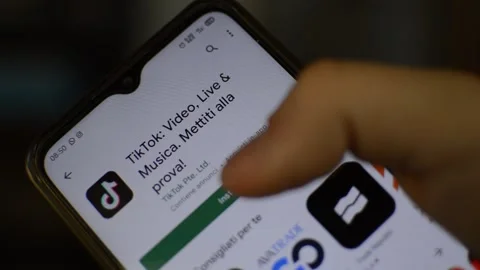 close up young man install tik tok app o... | Stock Video | Pond5