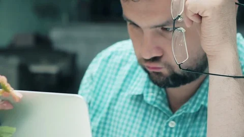 Close up of young man reading his tablet... | Stock Video | Pond5