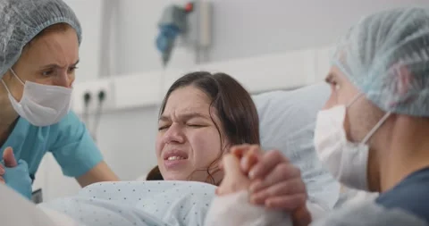 Close up of young woman giving birth in ... | Stock Video | Pond5