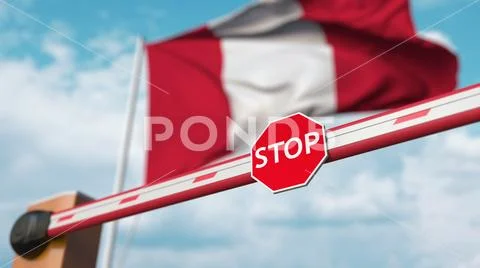 Closed boom barrier with stop sign against the Peruvian flag ...