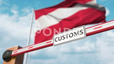 Closed boom gate with CUSTOMS sign on the Austrian flag background ...