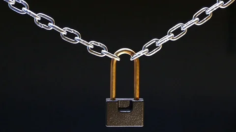 A closed lock with a steel chain hanging... | Stock Video | Pond5